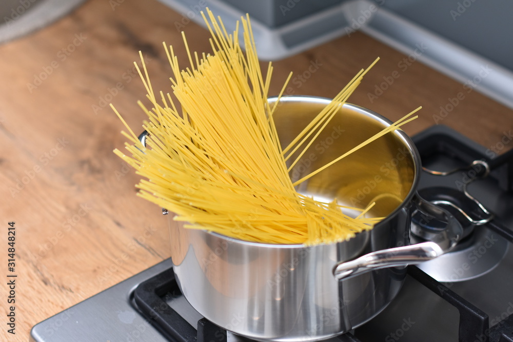 Spaghetti boiling in steel pan. Italian raw spaghetti. Stock Photo ...
