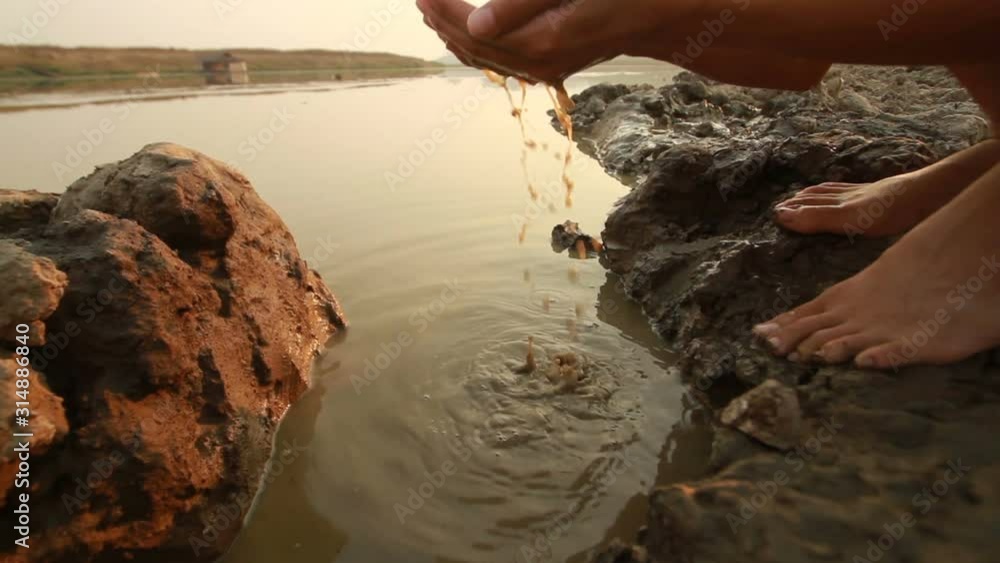 Hand of Thirsty Man taking water from drying river on summer metaphor ...