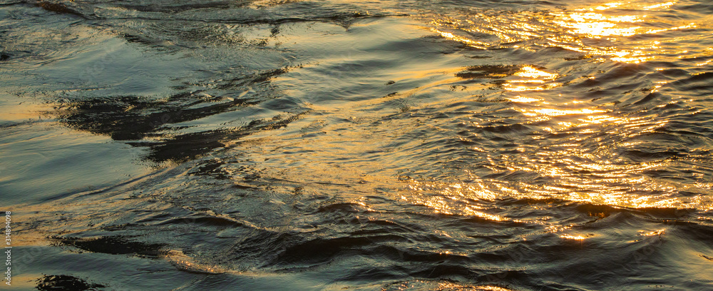 golden water wave reflection in sunset.Gold water texture. Stock Photo ...