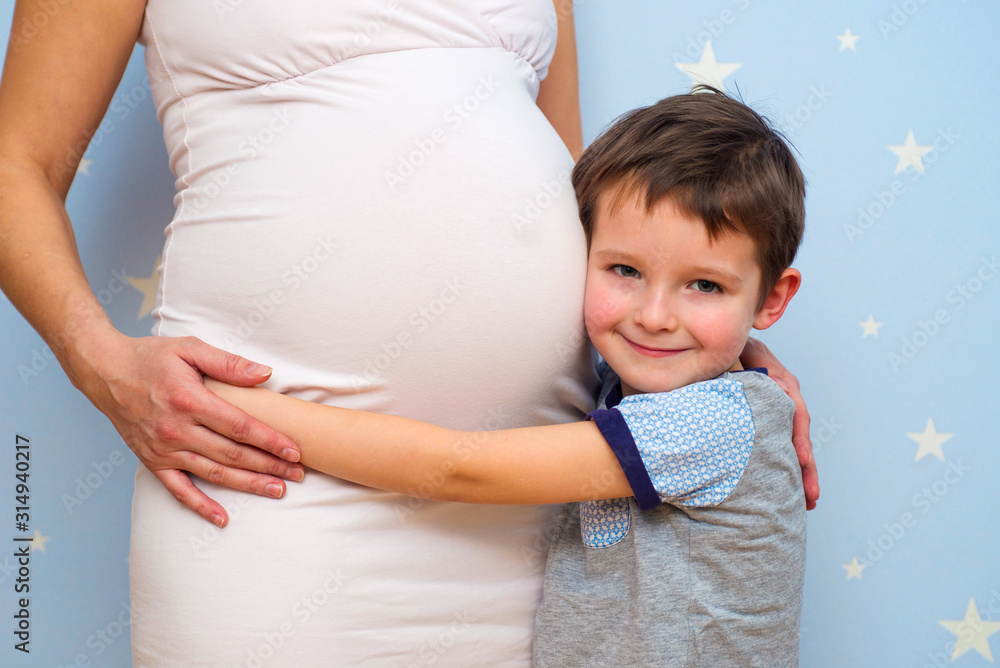 Cute child hugging belly pregnant mother. Happy kid hugging pregnant ...