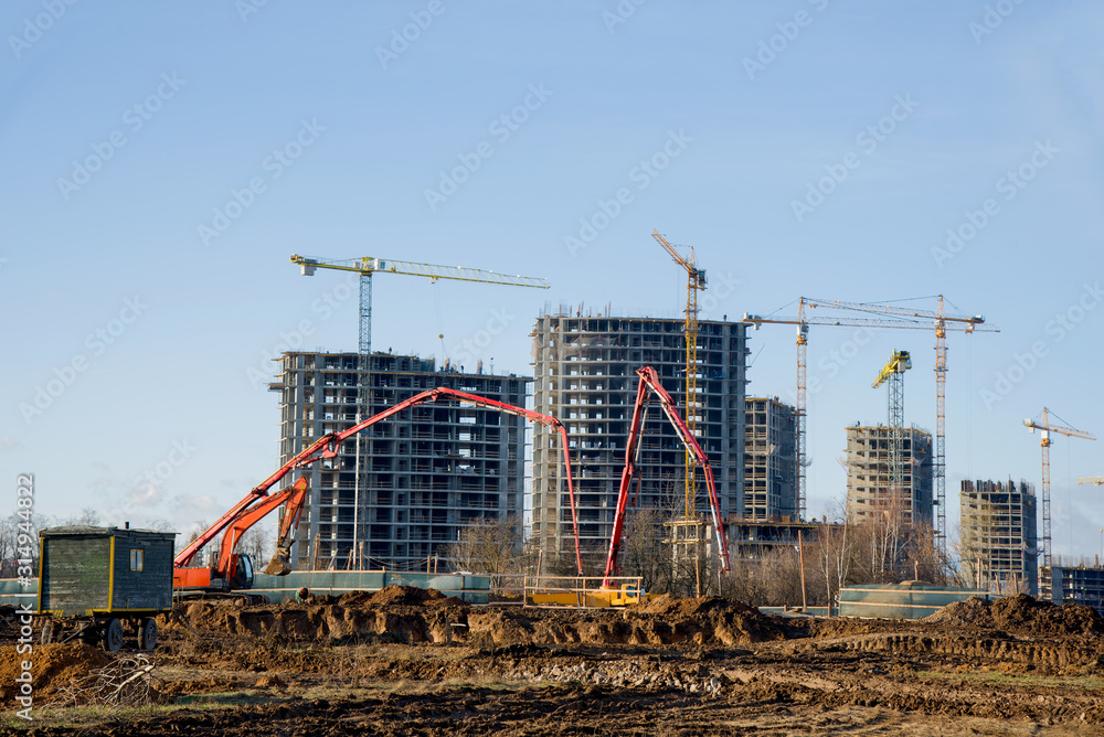 Hydraulic luffing jib tower cranes and workers being poured concrete ...