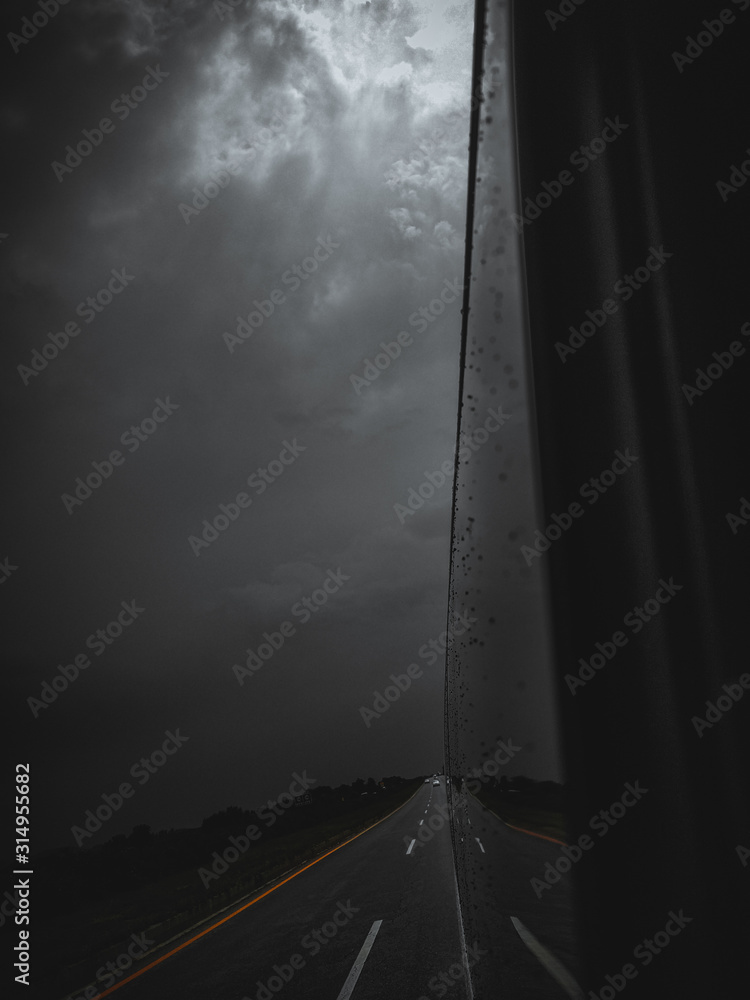 Rain drops on the mirror and light comes out from the darkness ...