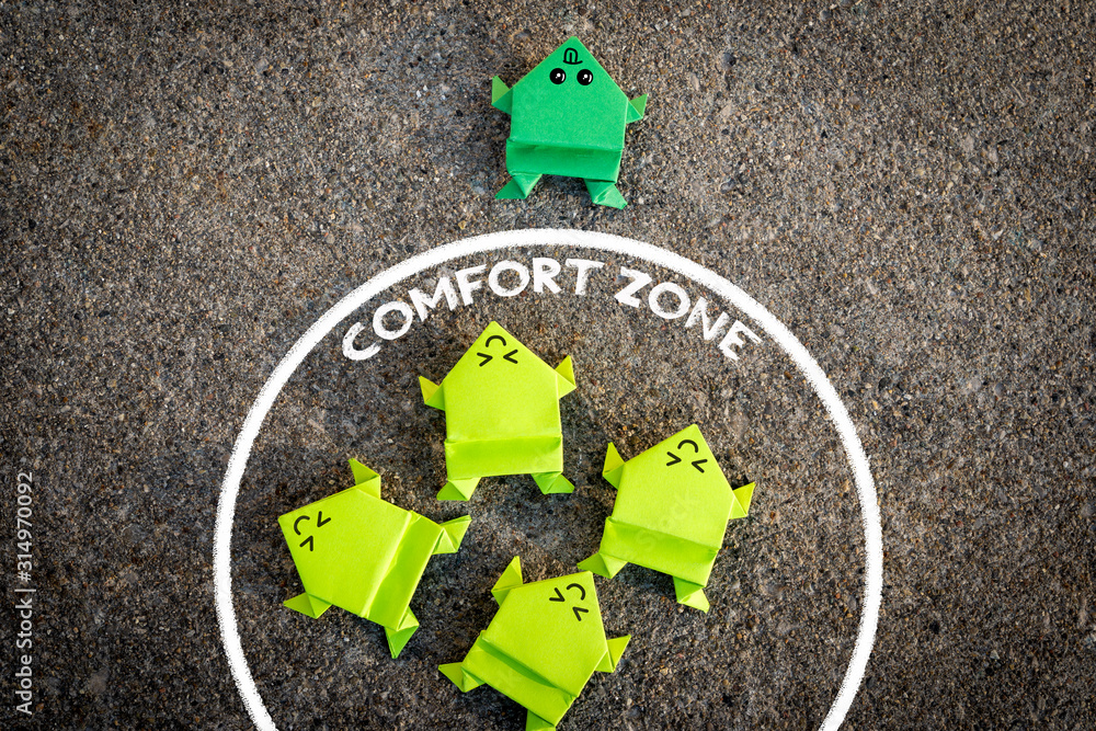 Exit from the comfort zone concept. Dark green frog jump out of the ...
