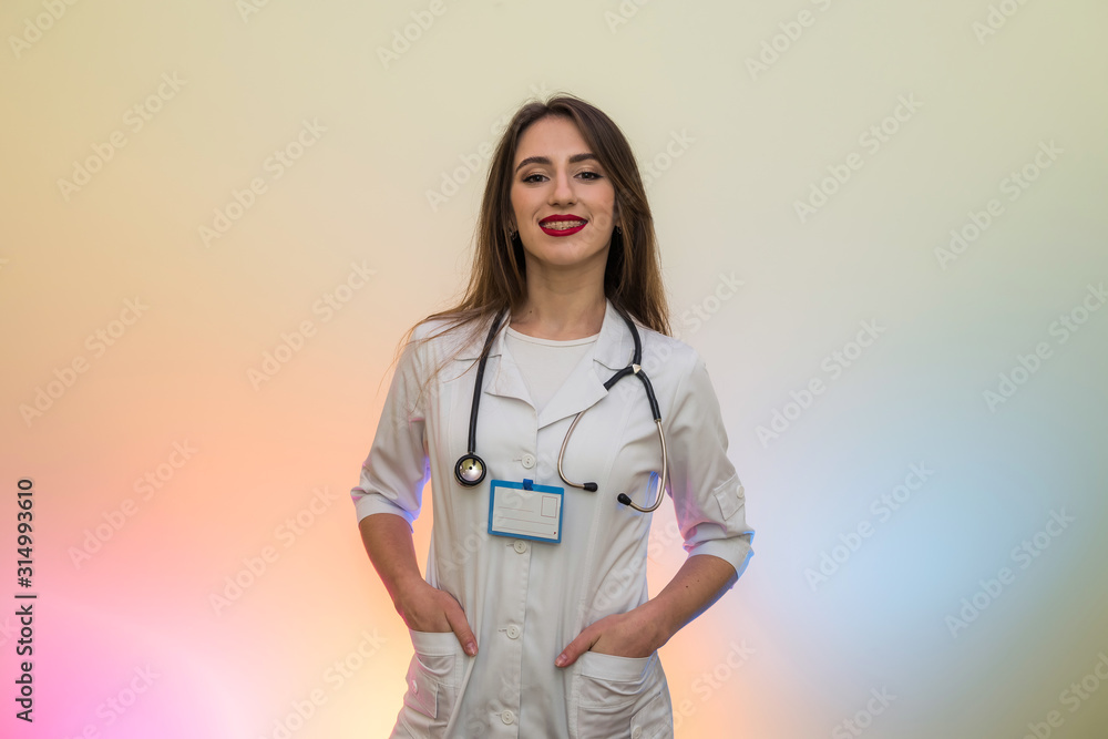 Cheerful and attractive doctor in medical uniform posing with ...