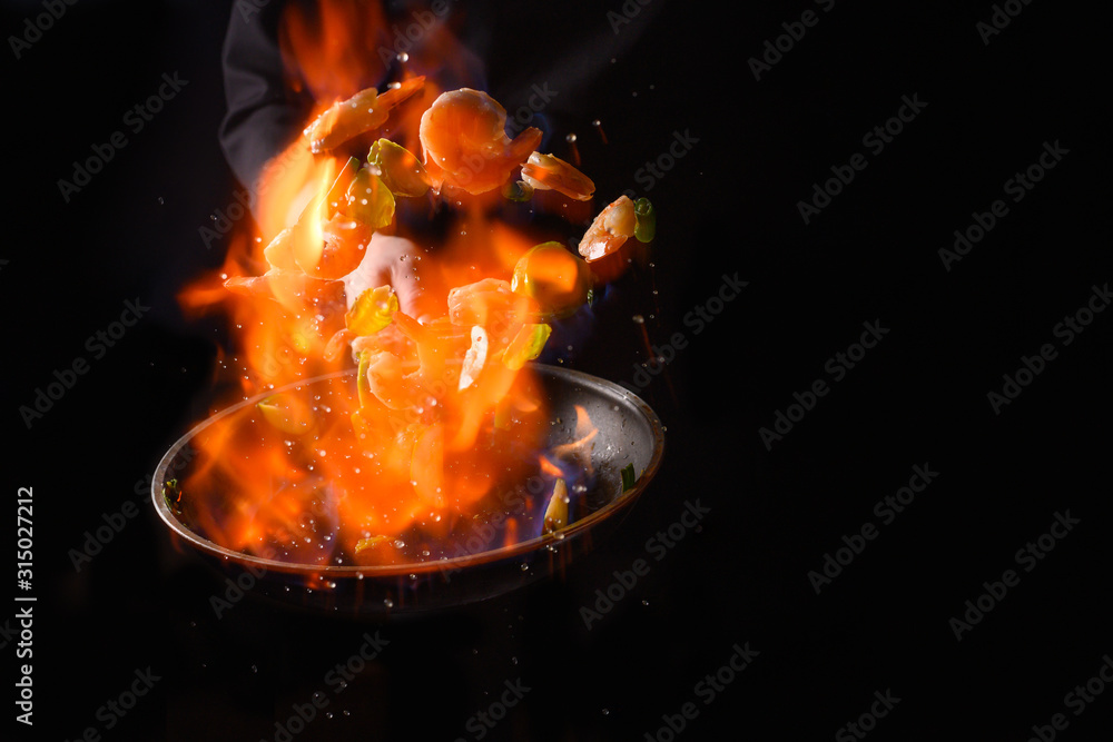 Professional cook cooks with fire. Cooking Cooking seafood, healthy ...
