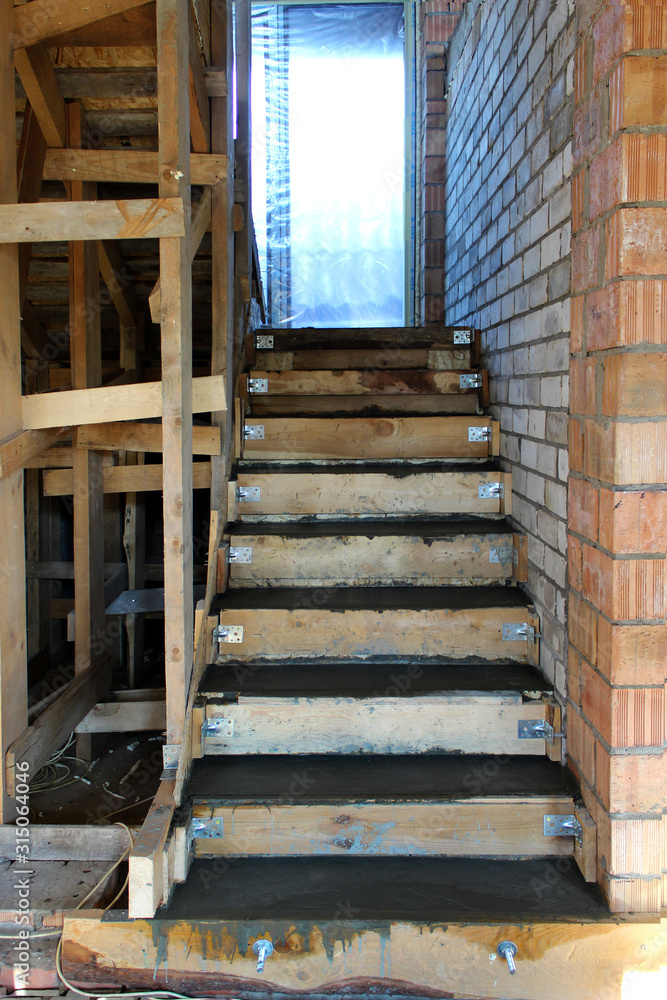 Metal reinforcement and wooden formworks of concrete stairway under ...
