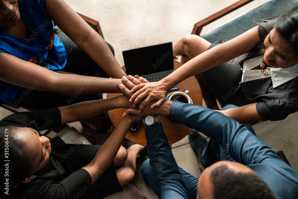 Top view of black african business team with hands stacked together in ...