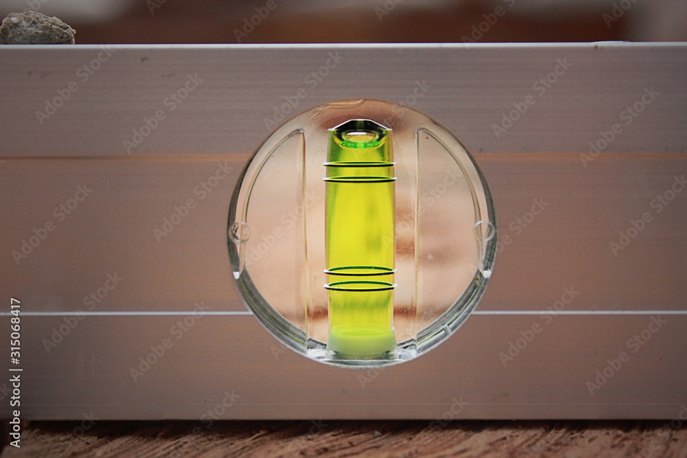 A close up image of a leveling tool being used. Construction bubble ...