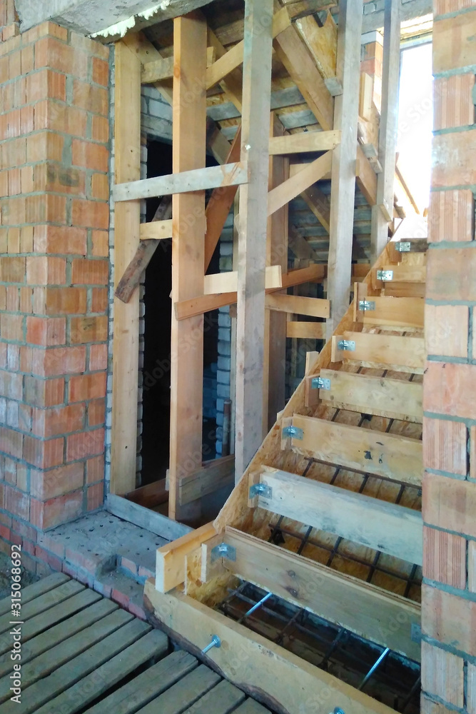 Metal reinforcement and wooden formworks of concrete stairway under ...