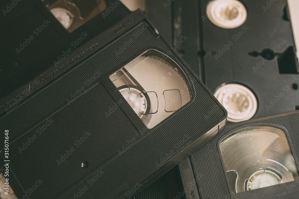 Stack of VHS video tapes as background. Retro technology. Stock Photo ...