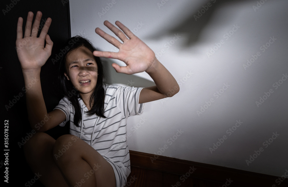 Sad asian child girl sitting on floor,showing hand signaling to stop ...