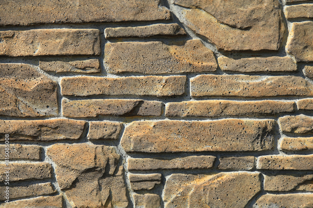 Beige-colored decorative stone wall, texture, background. Tan or light ...