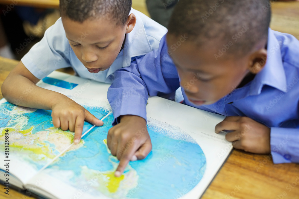Students using world map in class Stock Photo | Adobe Stock