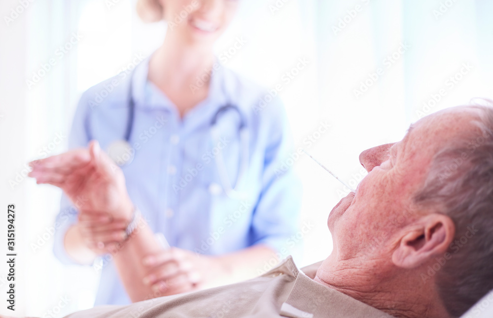 Doctor checking senior man‚Äôs pulse and temperature at checkup Stock ...