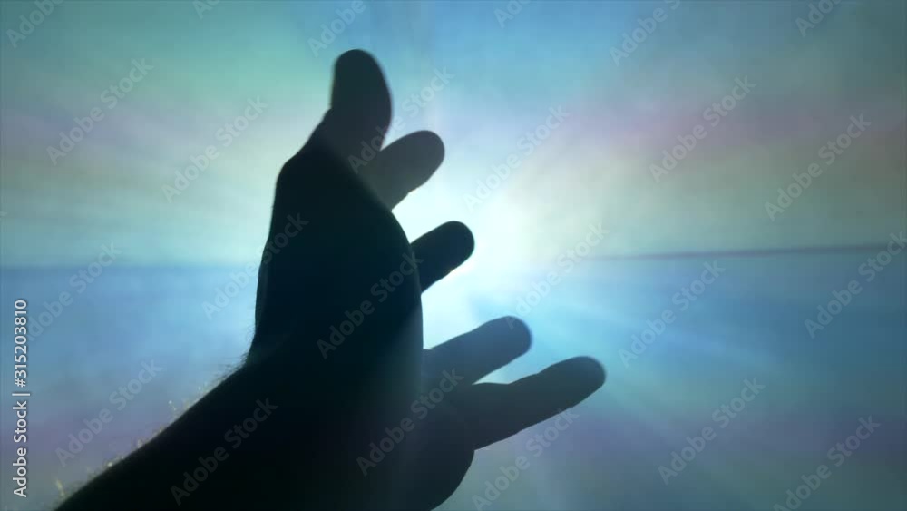 4K Shot Of Hand Reaching Out To Touch Beautiful Rays Of Light From ...