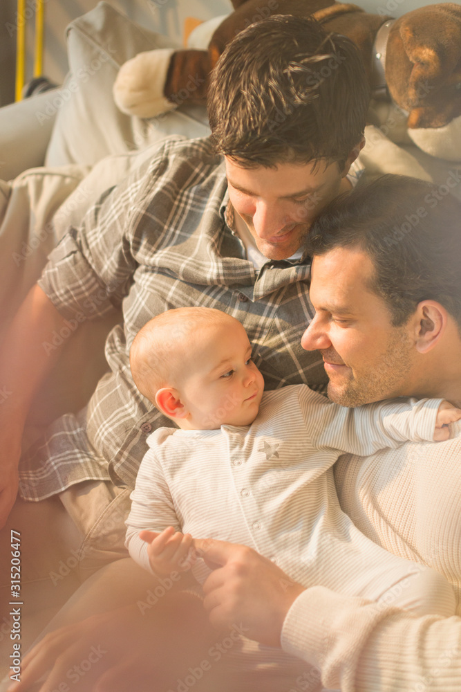 Affectionate male gay parents and son cuddling Stock Photo | Adobe Stock