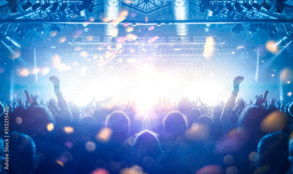 Concert stage shot from inside a concert hall with many people ...