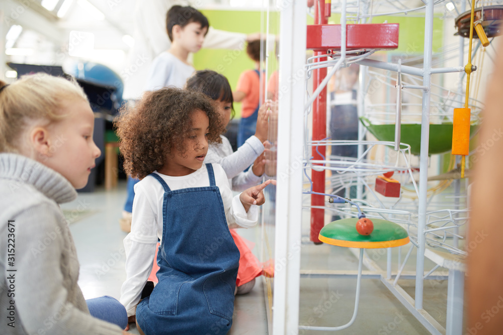 Curious kids watching exhibit in science center Stock Photo | Adobe Stock