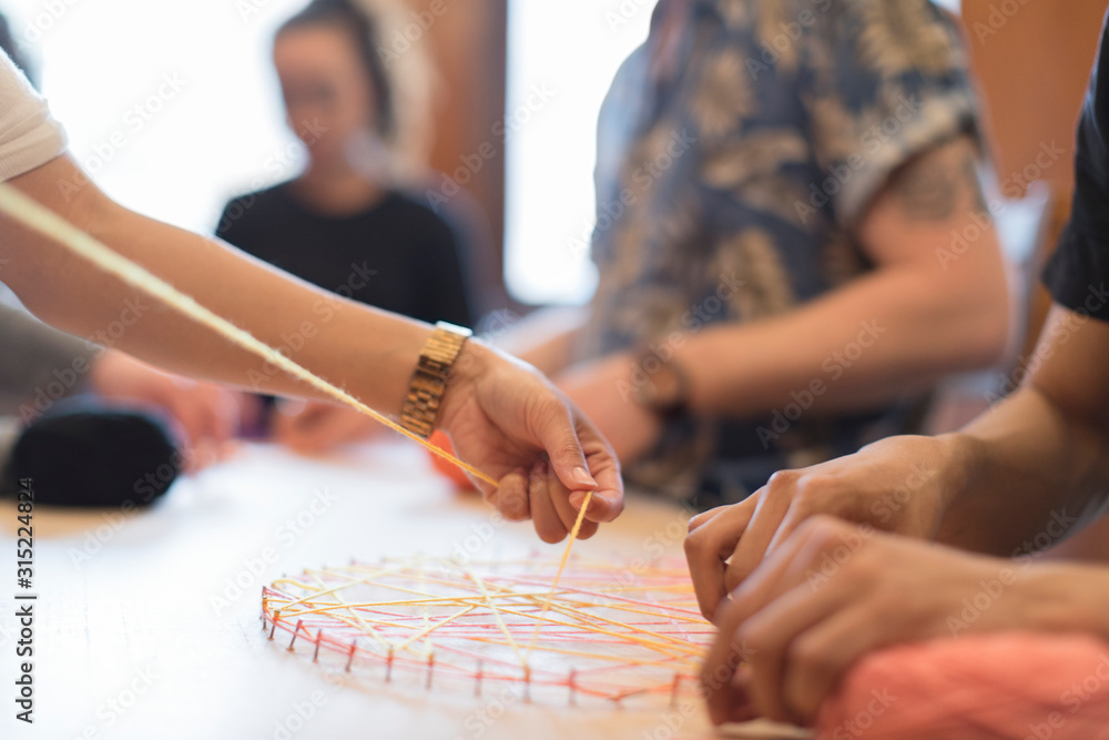 People doing string art project Stock Photo | Adobe Stock