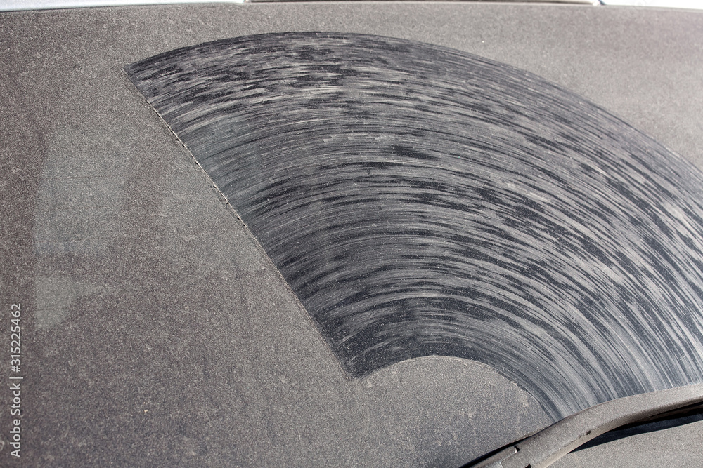 unmarked suv back window of a dirty car in a layer of dust and dry dirt ...