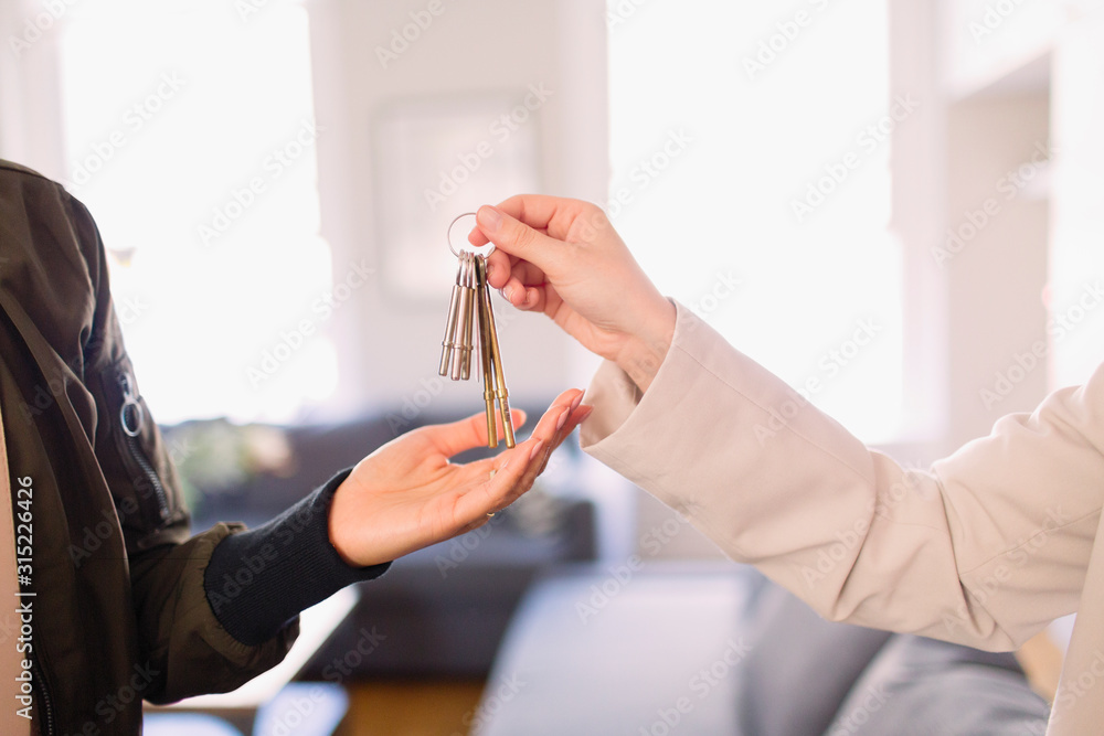 Real estate agent giving keys to homeowner Stock Photo | Adobe Stock