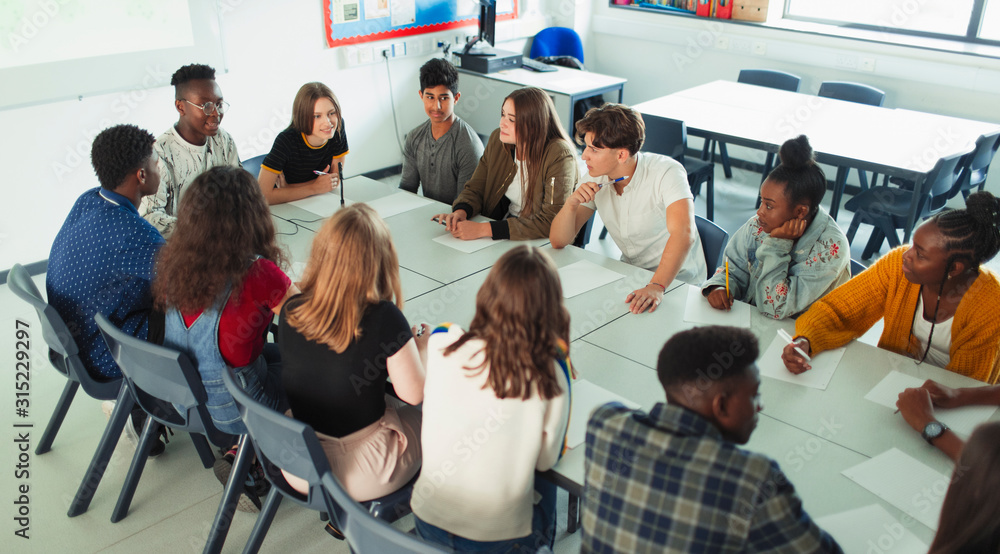 High school students talking at table in debate class Stock Photo ...