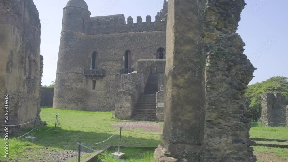 Camera tracking left reveal ruin structures and rear steps and facade ...