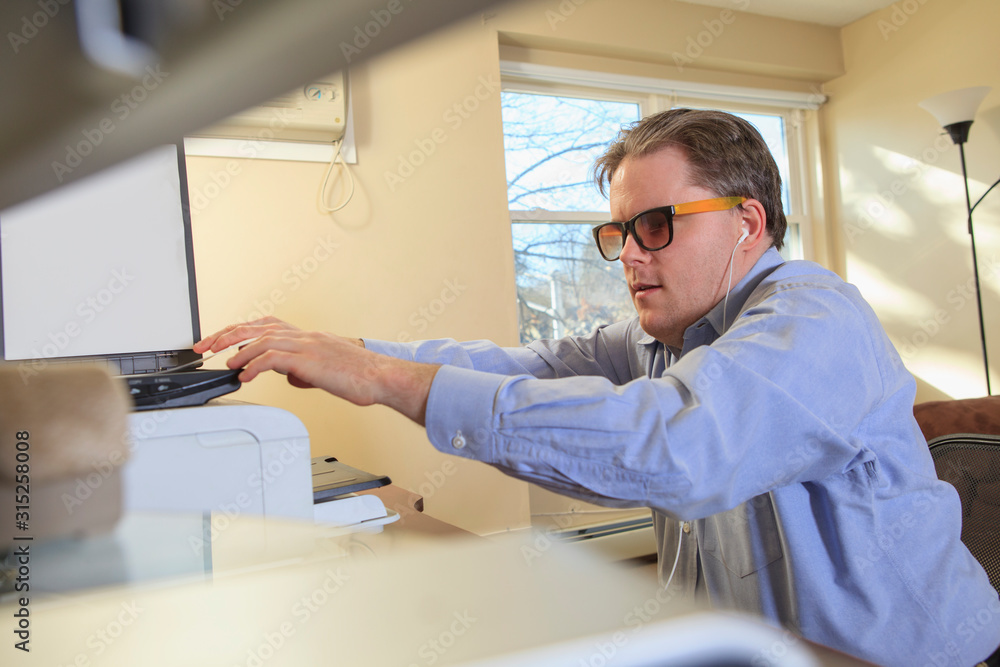 Blind man scanning paperwork at computer Stock Photo | Adobe Stock