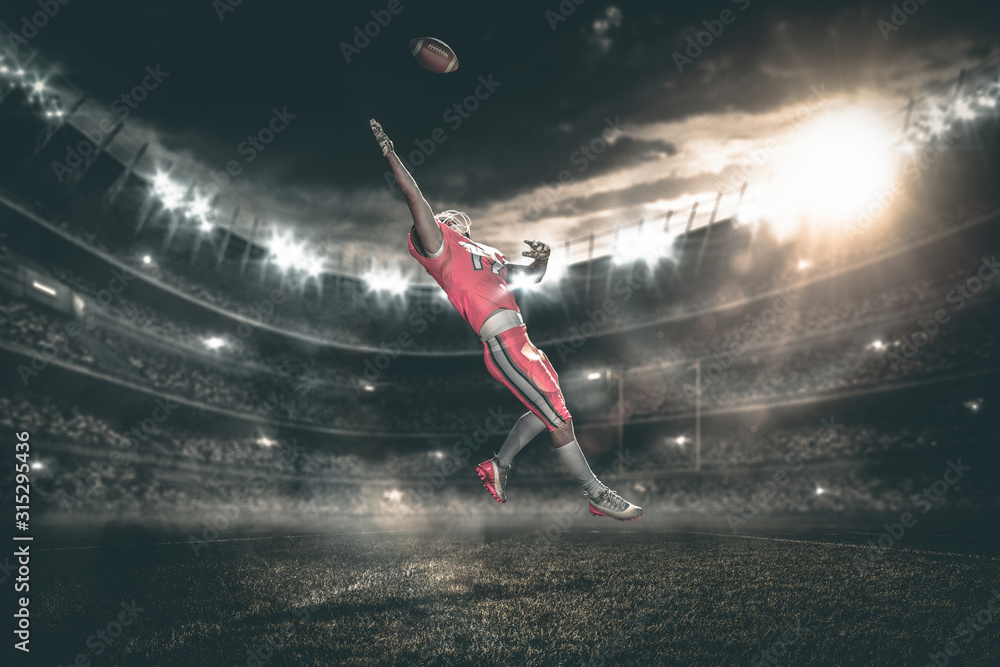 american football player catches ball in midair Stock Photo | Adobe Stock