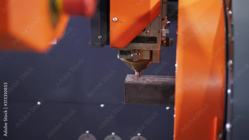 Metal tube laser cutting with modern CNC machine process. Cutter head ...