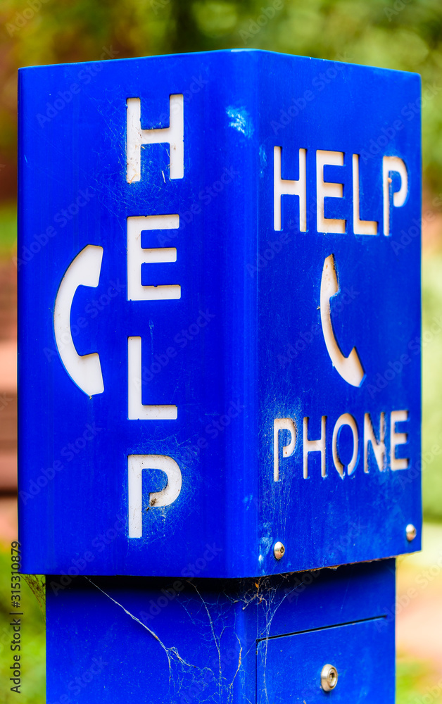 A blue emergency phone box labeled "HELP" at a university campus in ...