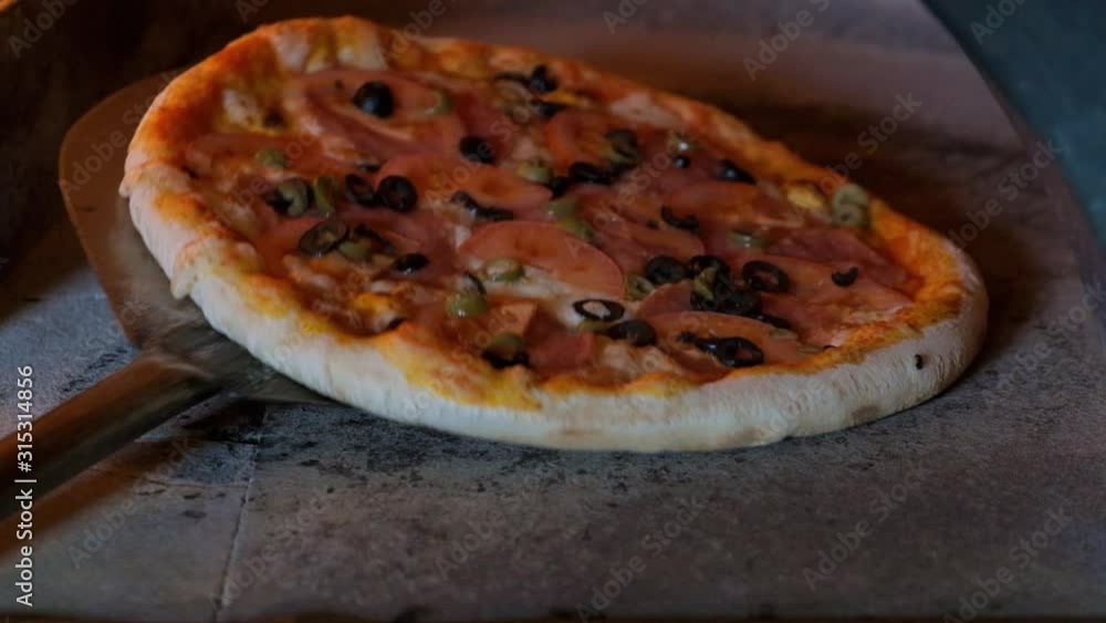 Italian pizza with tomatoes is cooked in the oven, restaurant chef ...