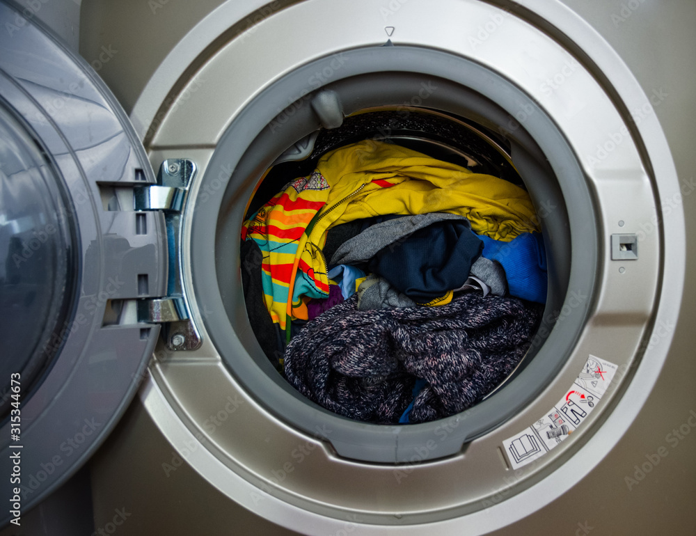 Washing machine with dryer, freshly washed clothes and dried in ...