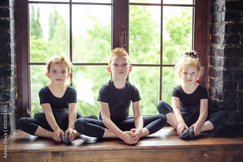 Portrait of 3 little children dancer two girls and one boy in black ...