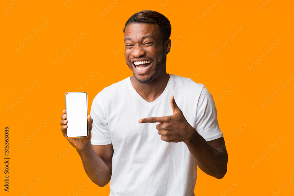 Guy Pointing Finger At Phone Screen Laughing, Orange Background, Mockup ...
