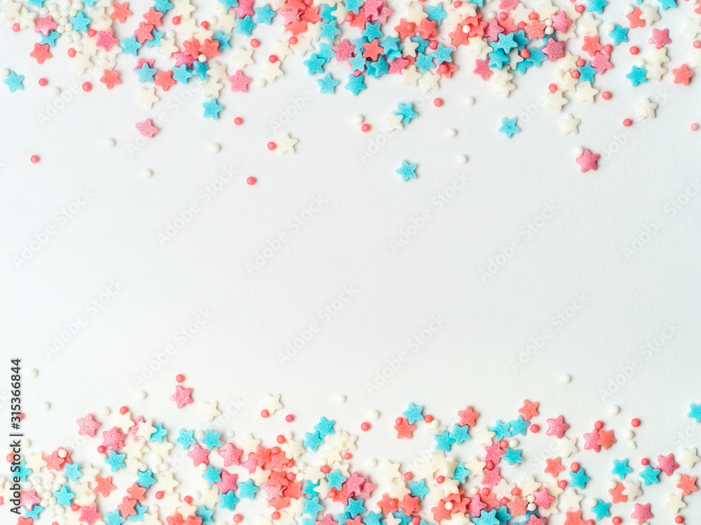 Festive border frame of colorful pastel sprinkles on white background ...