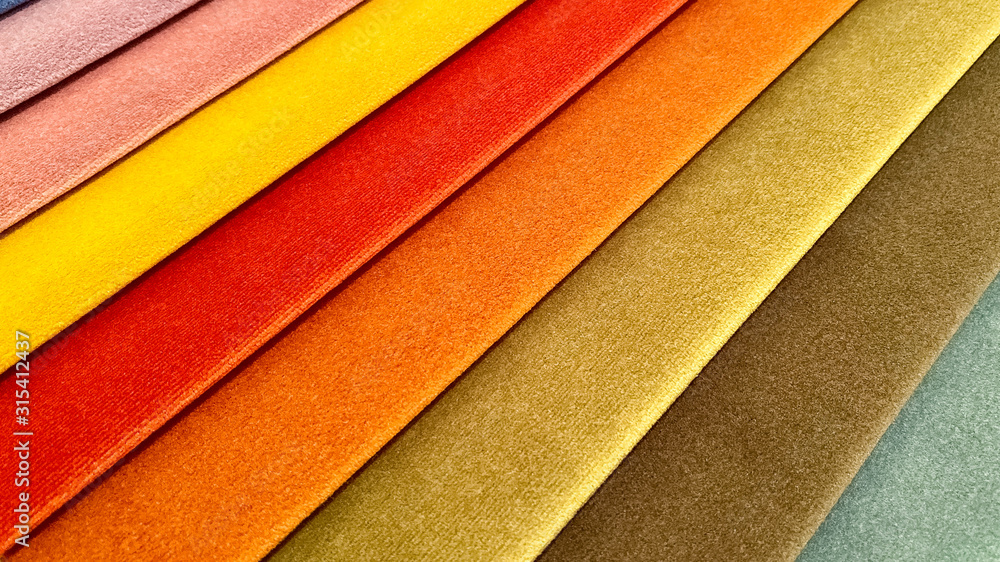 Perspective of a palette of fabric samples of multi-colored shades ...