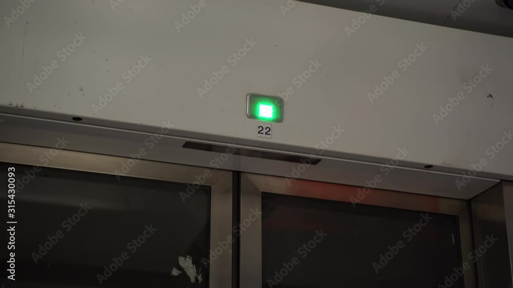 Blinking green light sign of automatic opening doors of train or metro ...