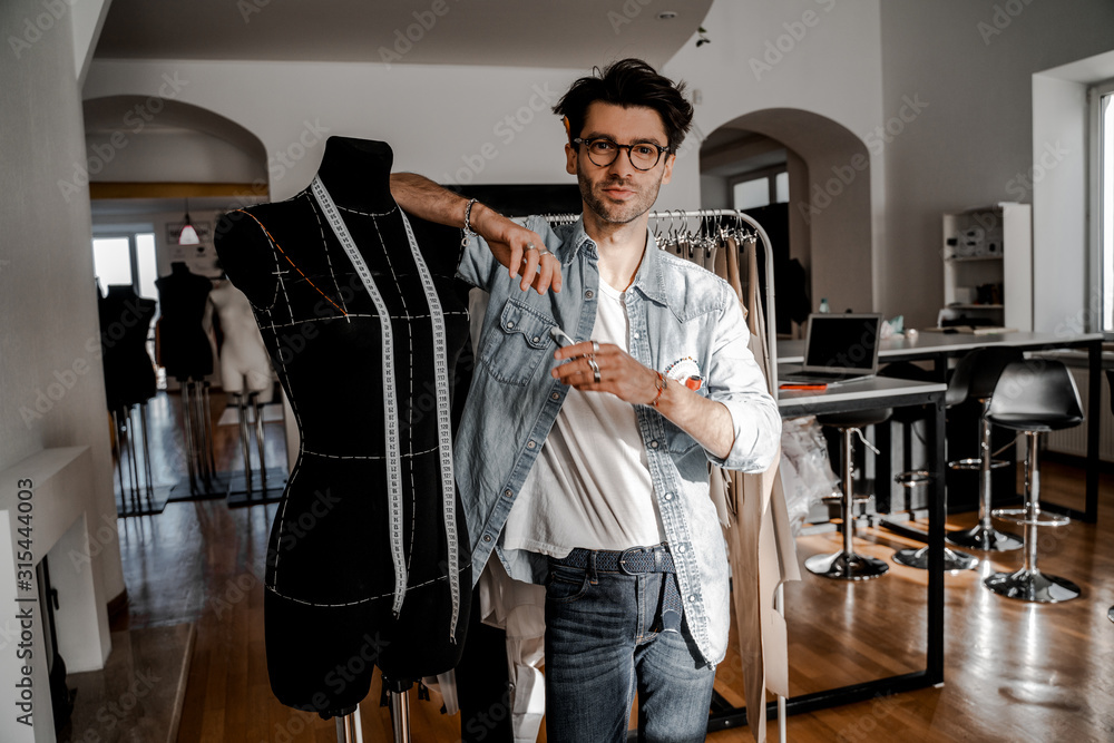 Handsome professional man in stylish clothes in his design studio ...