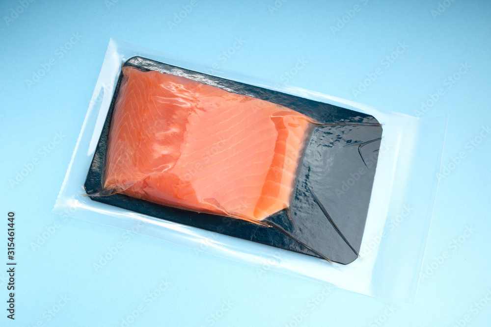 Raw Sea-fish steak packaged in plastic vacuum container. Top view of ...