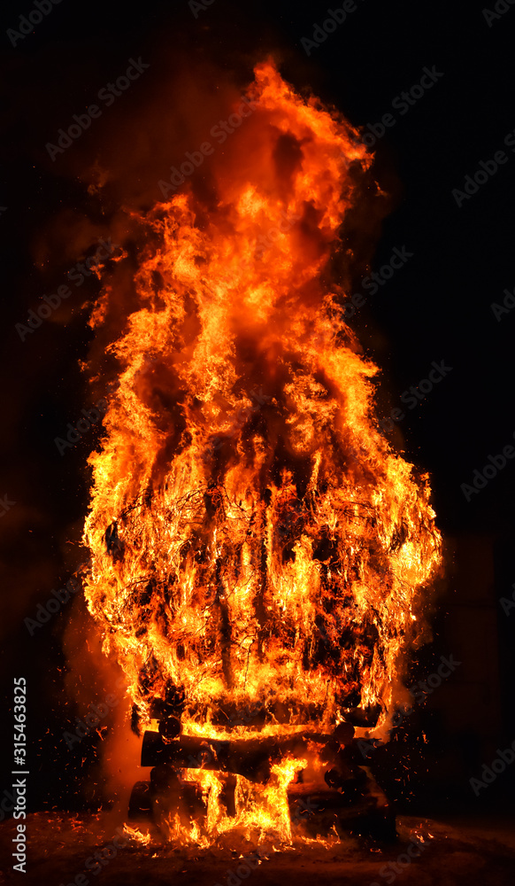 amazing violent bonfire of fire in a village in the dark night. The ...