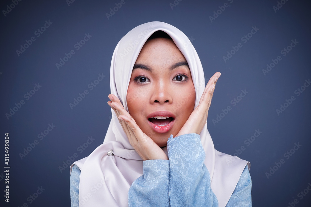 Headshot of a cute Muslim teenager wearing hijab showing various facial ...