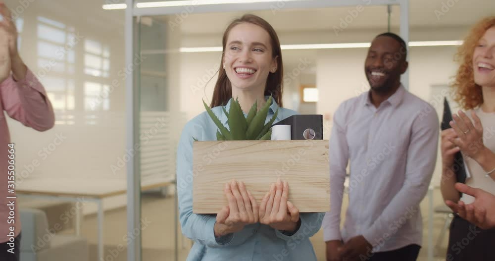 Excited girl trainee getting promotion and walking with things in box ...