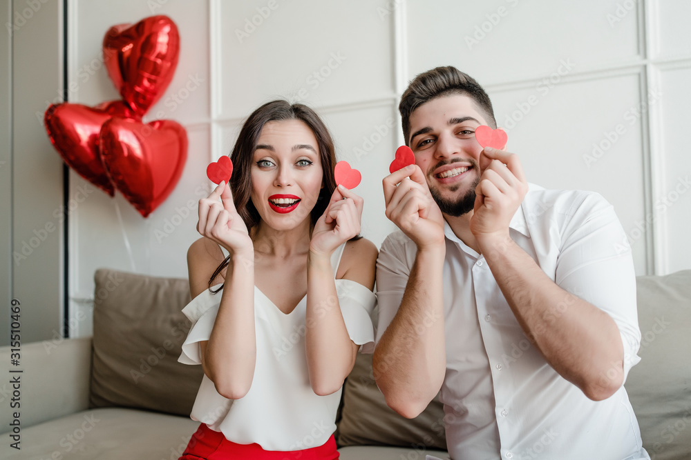 goofy couple boyfriend and girlfriend covering eyes with heart shapes ...