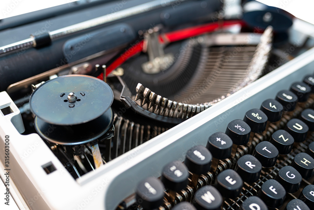 Classic, manual typewriter in white with a German keyboard layout ...