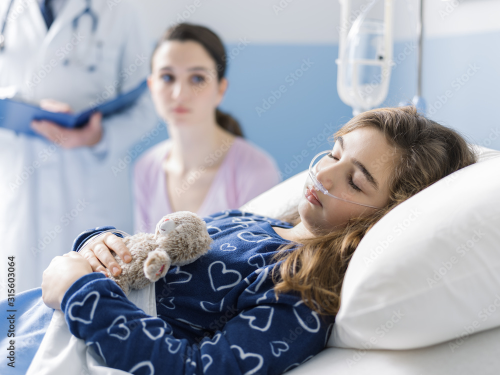 Hospitalized child lying in bed at the clinic Stock Photo | Adobe Stock