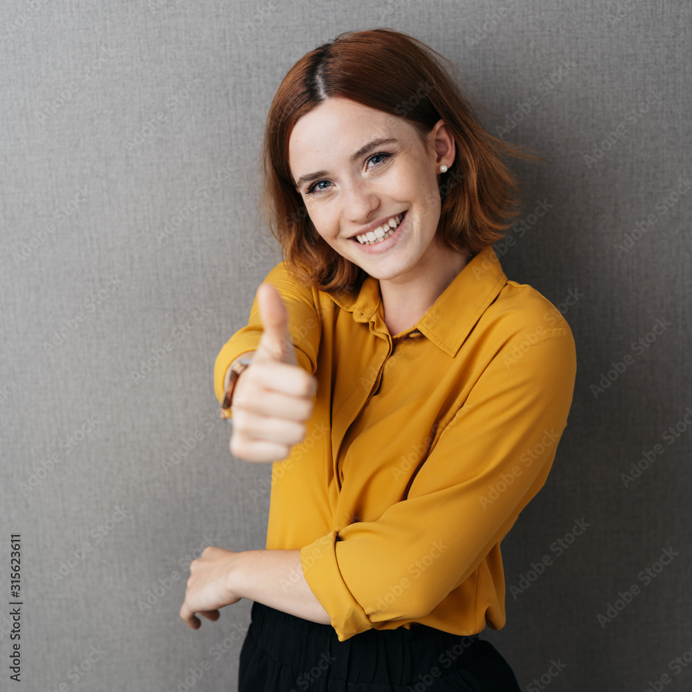 Excited elated woman giving a thumbs up gesture Stock Photo | Adobe Stock