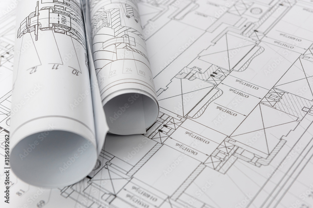 Technical drawings with blueprints in rolls close up. Engineering ...
