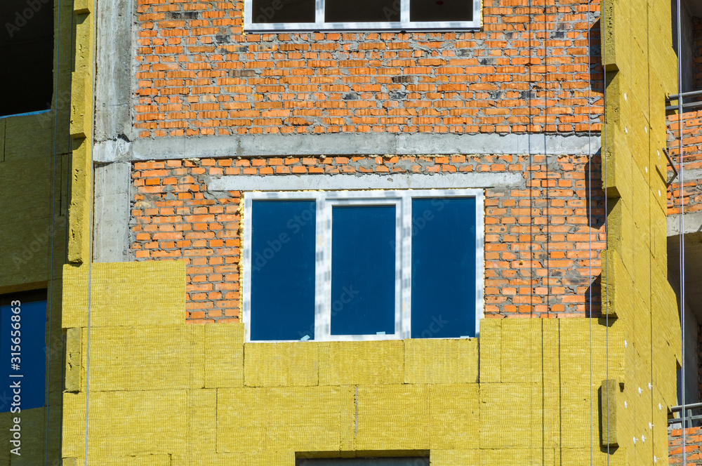 work on the external walls of glass wool insulation and plaster Stock ...