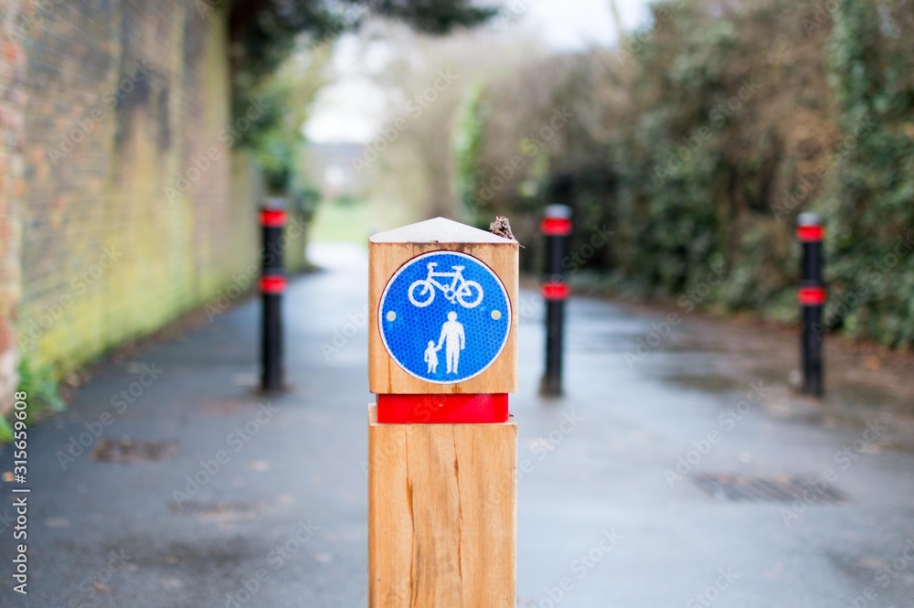 Shared cycle and walking path signboard at the entrance of a park cycle ...